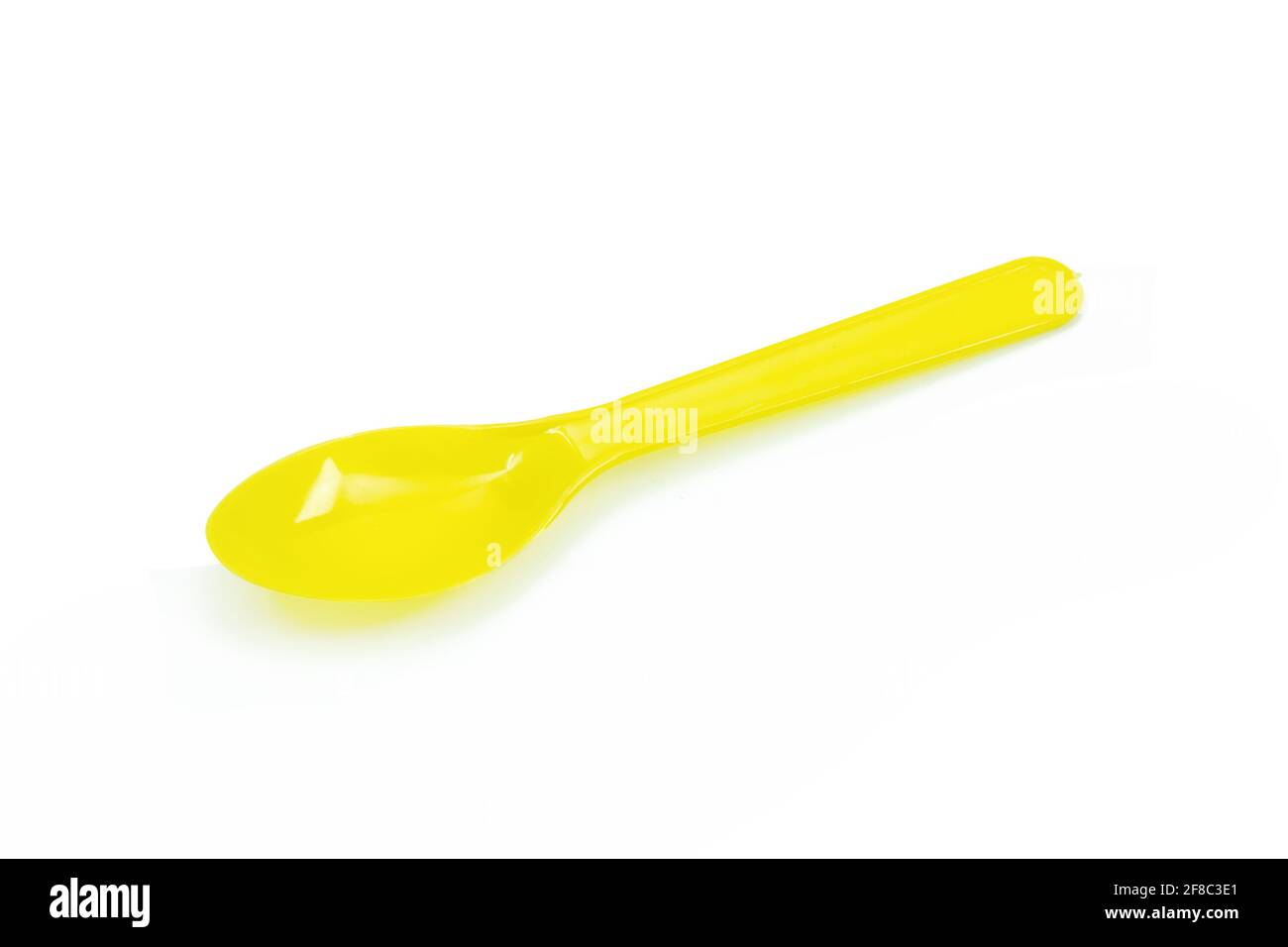 Yellow plastic spoon isolated on white background Stock Photo - Alamy