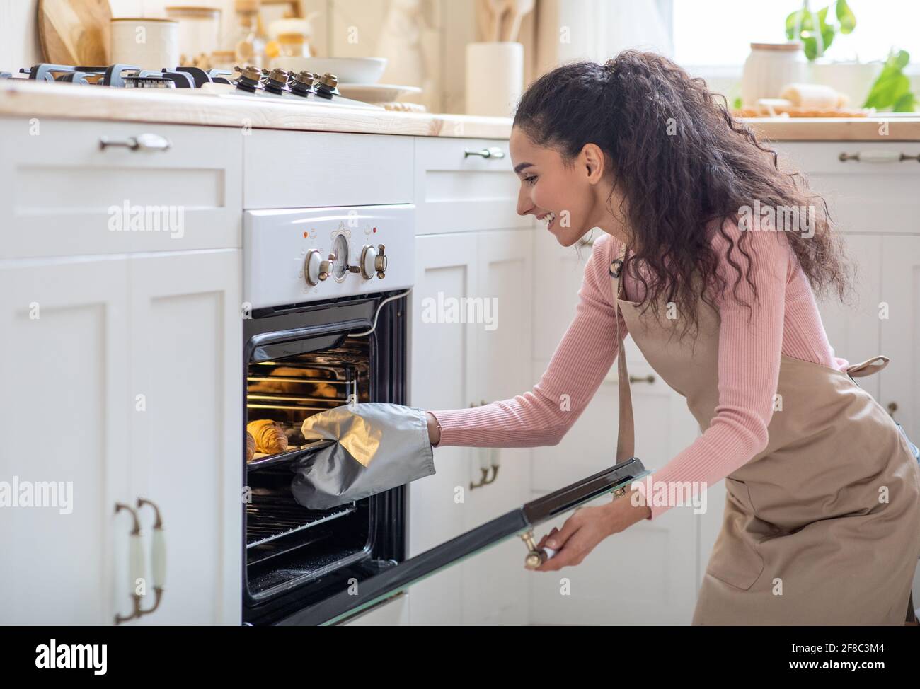 Baking At Home. Young Happy Lady Cooking Croissants In Kitchen Stock ...