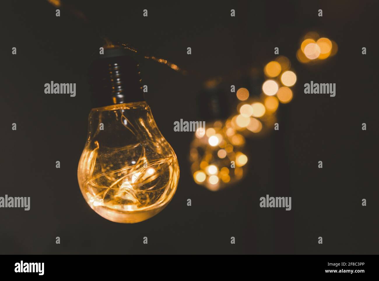 String Light bulbs hanging on a line Stock Photo - Alamy