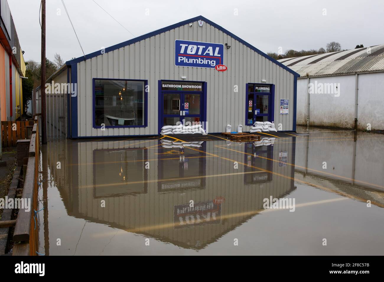 A plumbing merchant shop is flooded with water creating huge puddle at ...