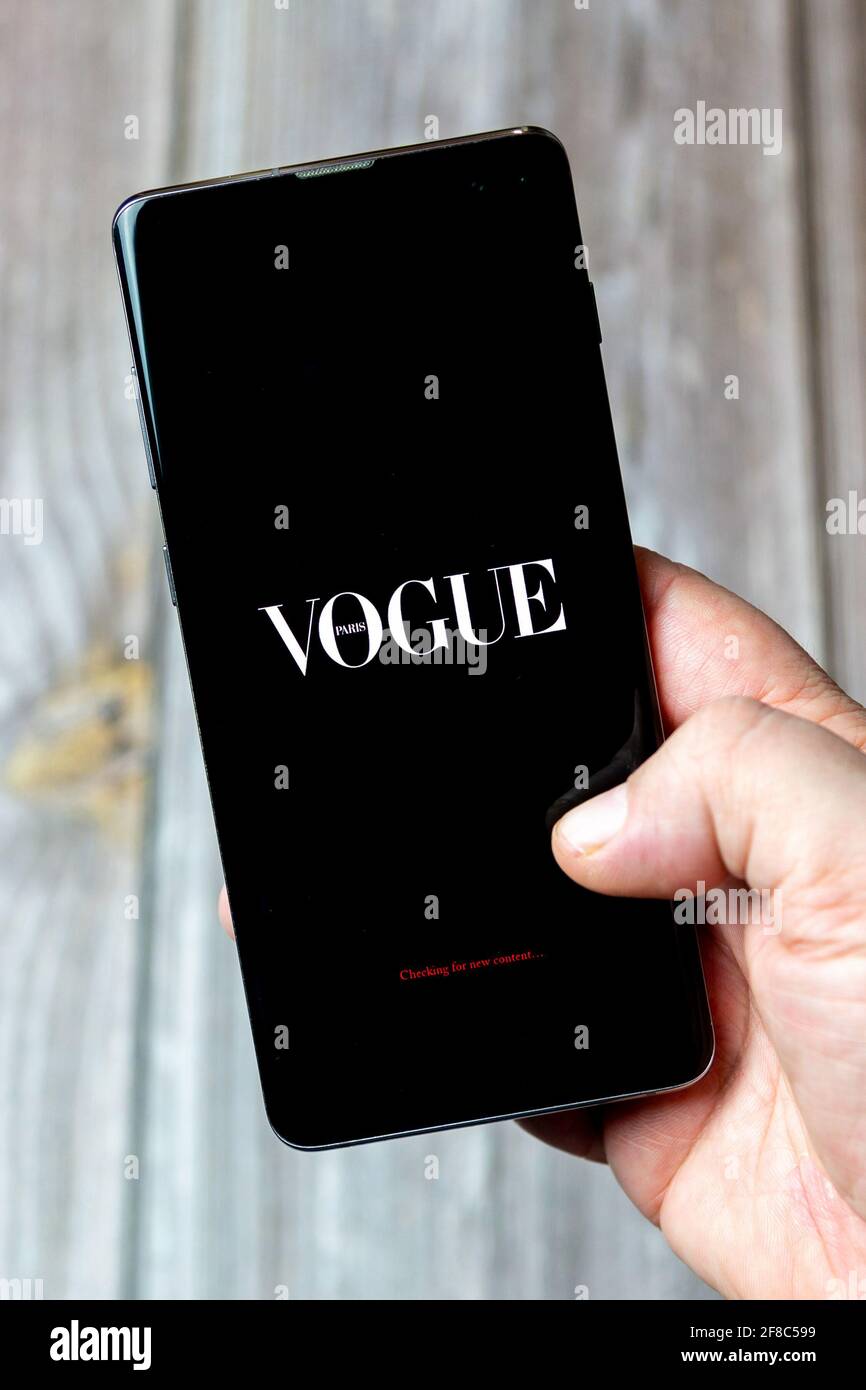A Mobile phone or cell phone being held in a hand with the Vogue ...