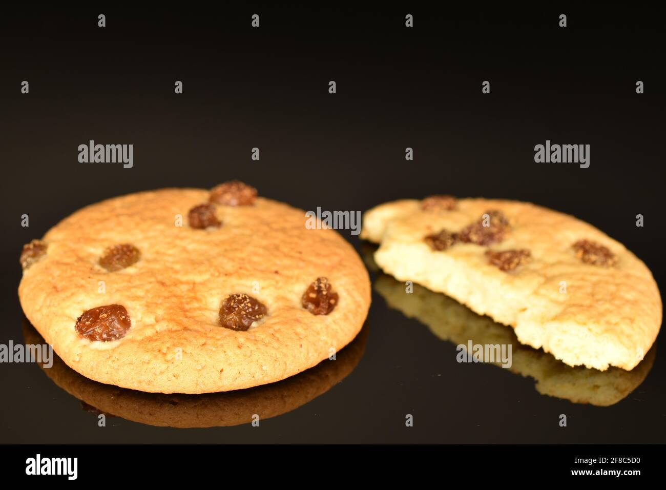 One whole and one half cookie, close-up, isolated on black Stock Photo ...