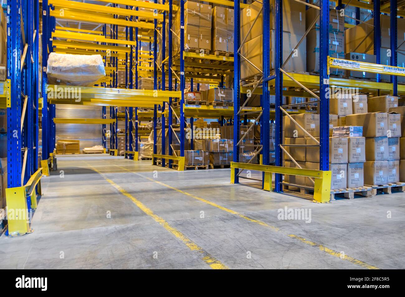 Interior of a modern warehouse storage with rows and goods boxes on ...