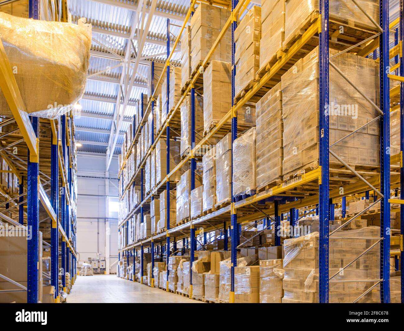 Interior of a modern warehouse storage with rows and goods boxes on ...
