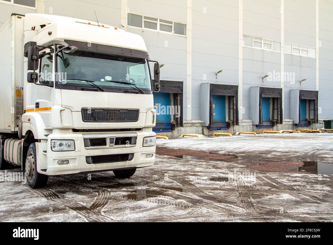 Truck while loading in a big distribution warehouse with gates for for ...