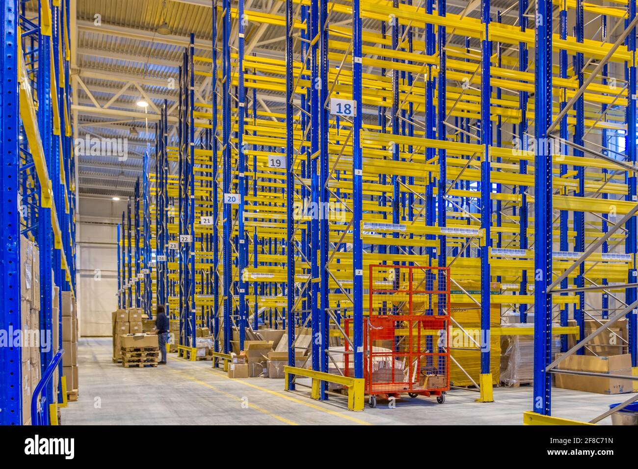 Interior of a modern warehouse storage with empty rows and high blue ...