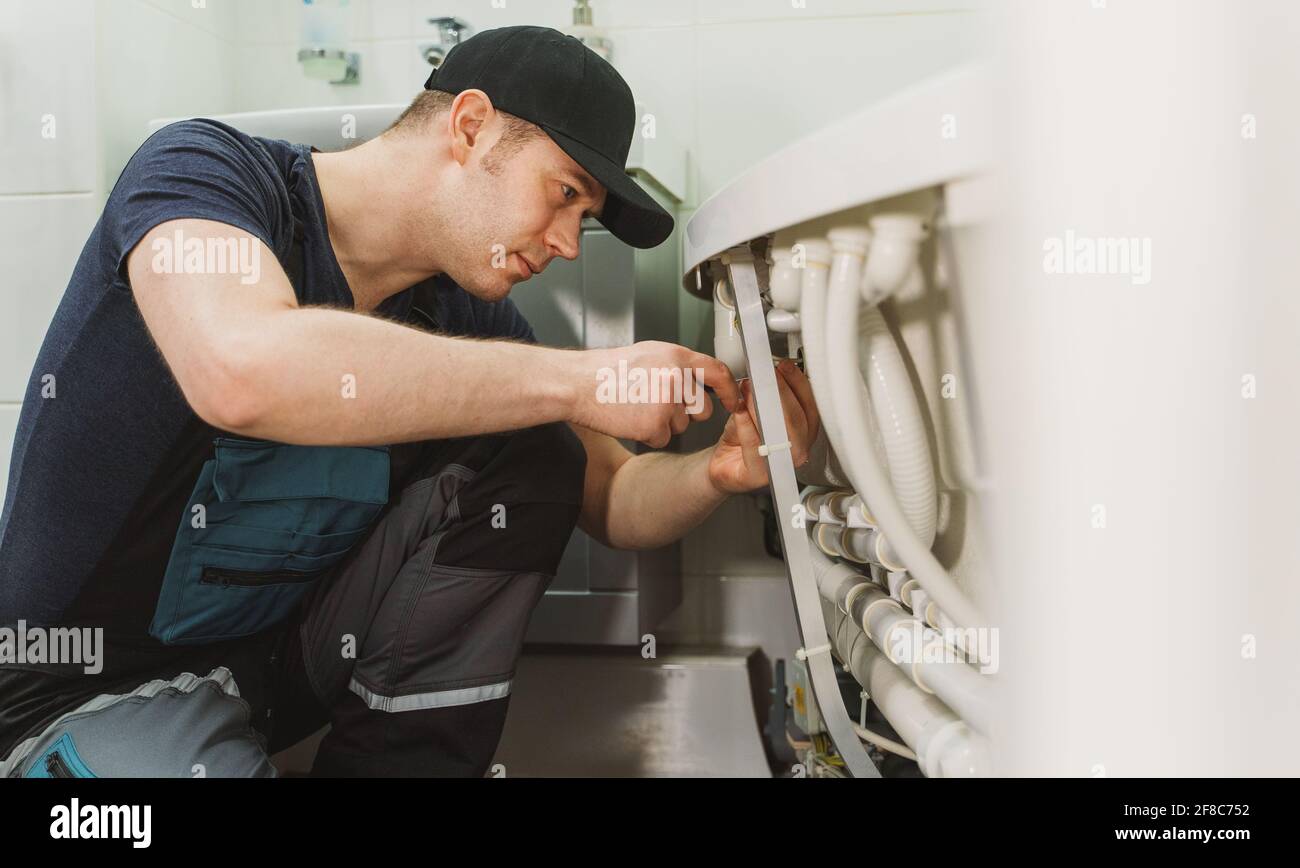 Man installing pipe system of bathtub with hydromassage Stock Photo - Alamy