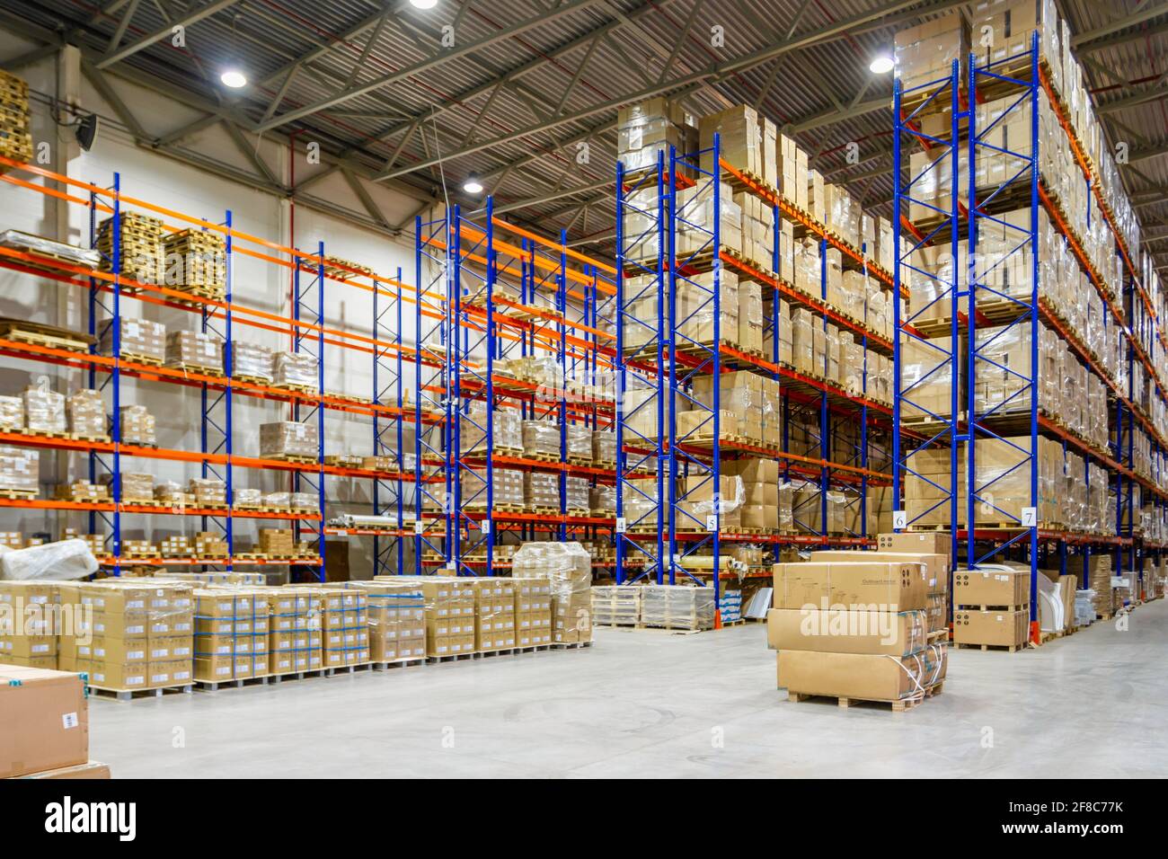 Interior of a modern warehouse storage of retail shop with pallet truck ...