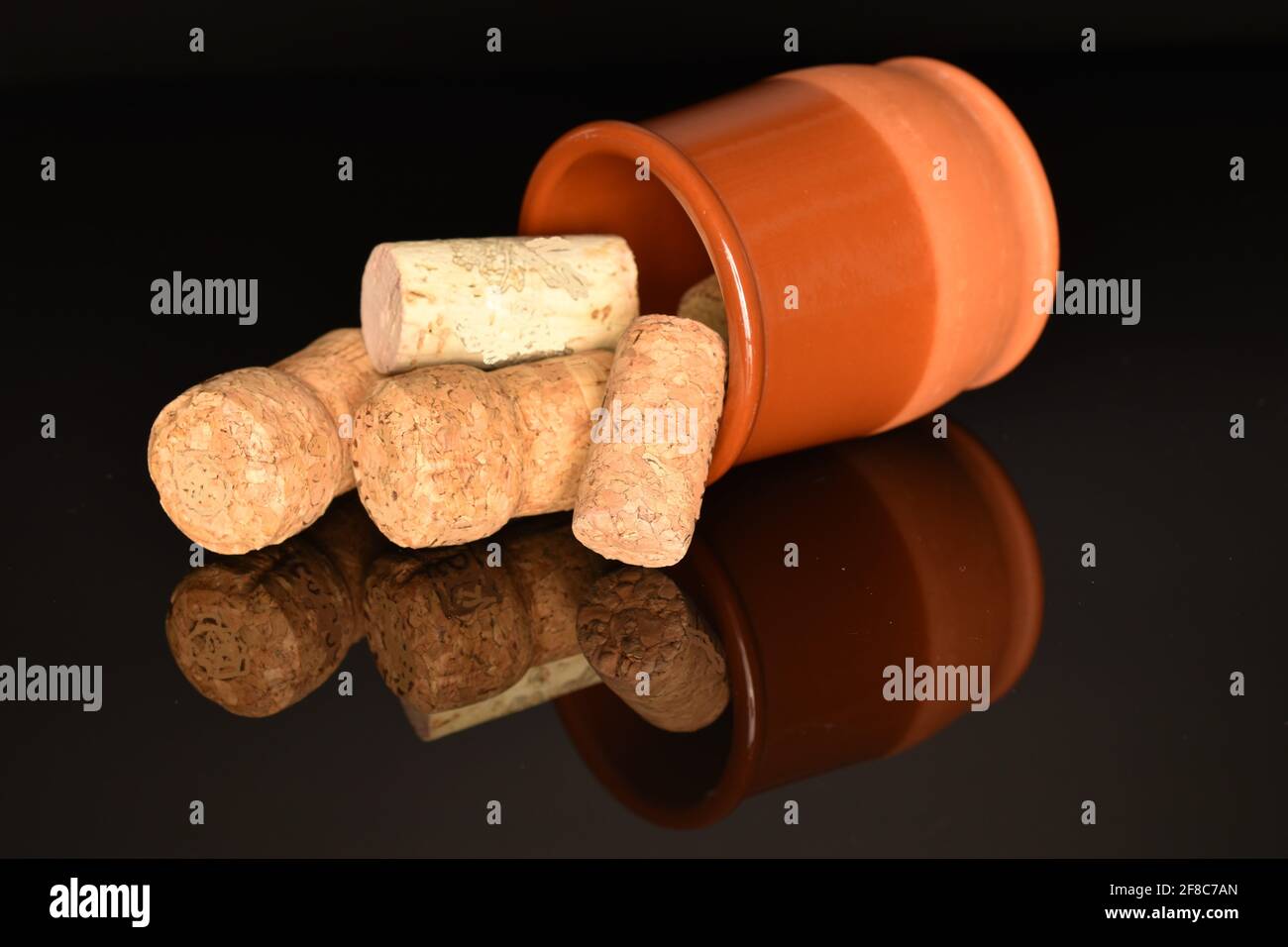 Several light brown, wine corks with a ceramic glass, close-up on a ...