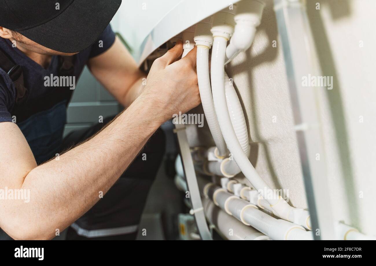 Man installing pipe system of bathtub with hydromassage Stock Photo - Alamy