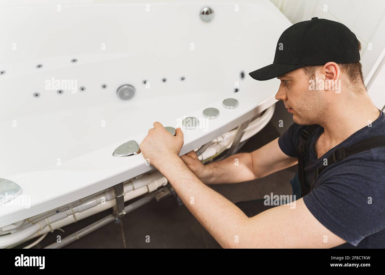 Man installing pipe system of bathtub with hydromassage Stock Photo - Alamy