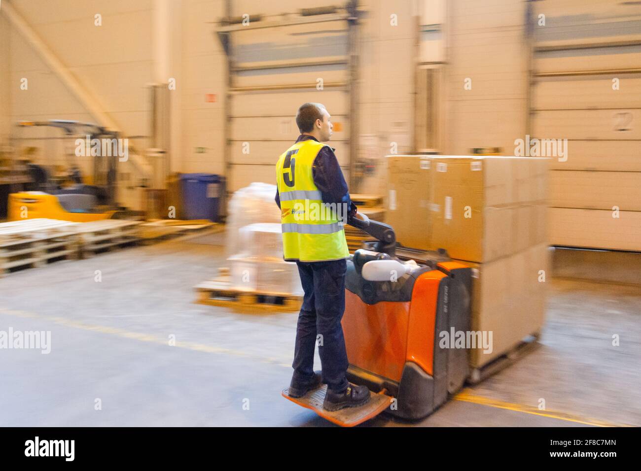MOSCOW, RUSSIA - MARCH 18, 2021 Warehouse worker driving a forklift ...