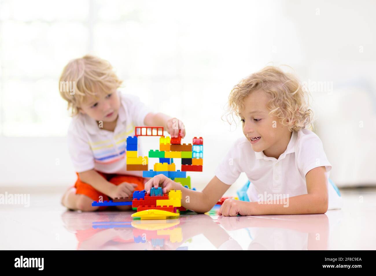 Child playing with colorful toy blocks. Kids play with plastic bricks ...