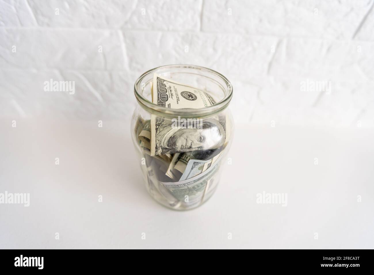 100 dollar bills jar hi-res stock photography and images - Alamy