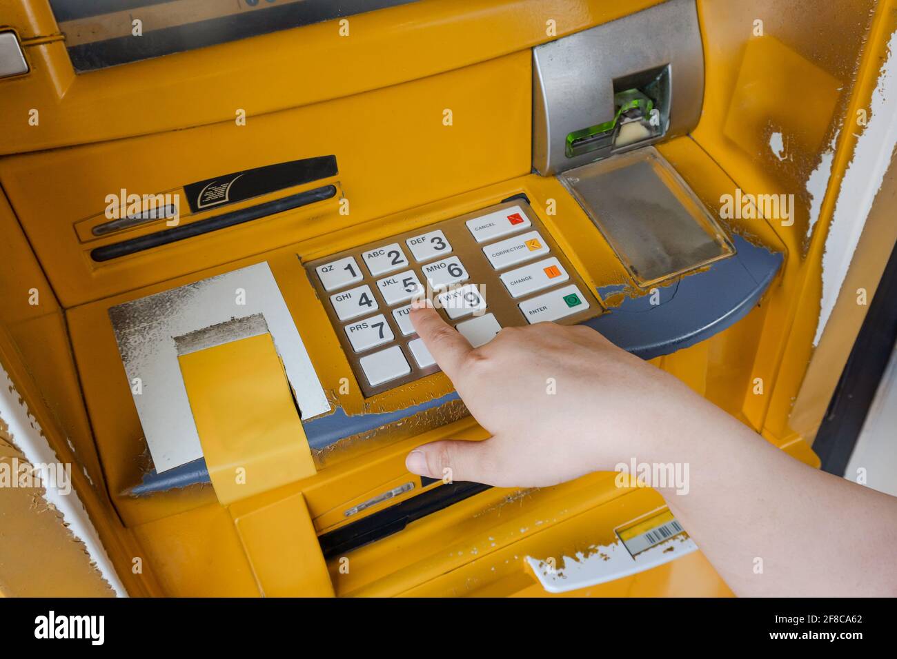 Close up of woman hand entering password code on ATM bank machine ...