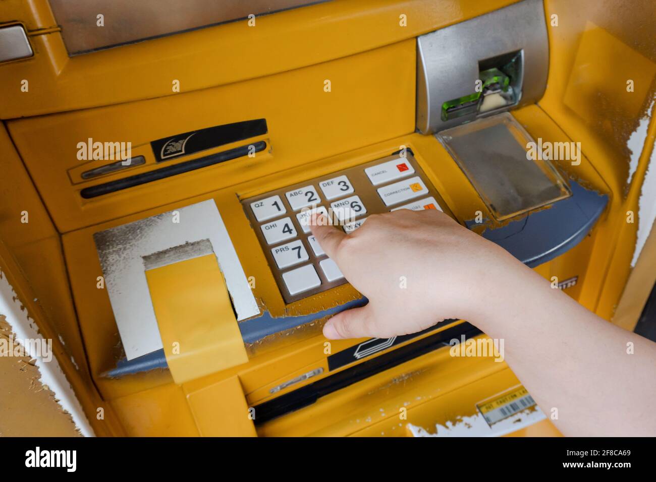 Close up of woman hand entering password code on ATM bank machine ...