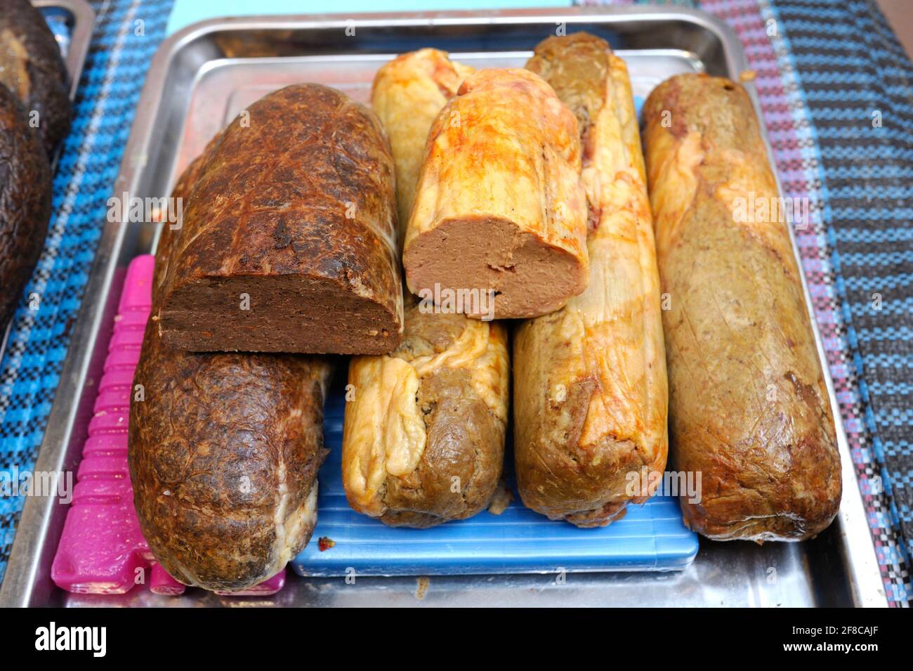 Sticks of meat paste placed on a counter, sausages Stock Photo - Alamy
