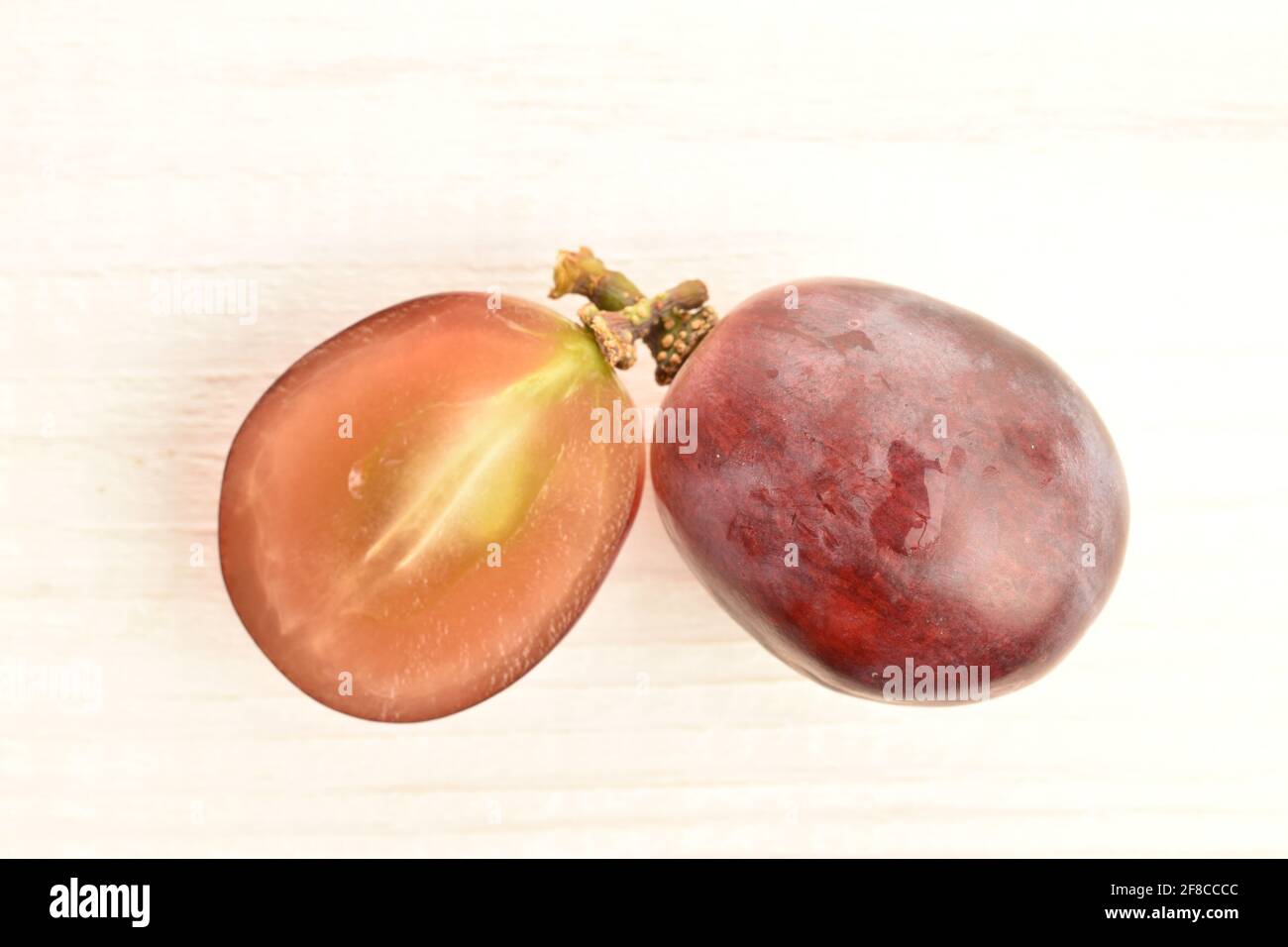 One whole and one half, fresh organic, juicy, ripe, sweet grapes, close ...