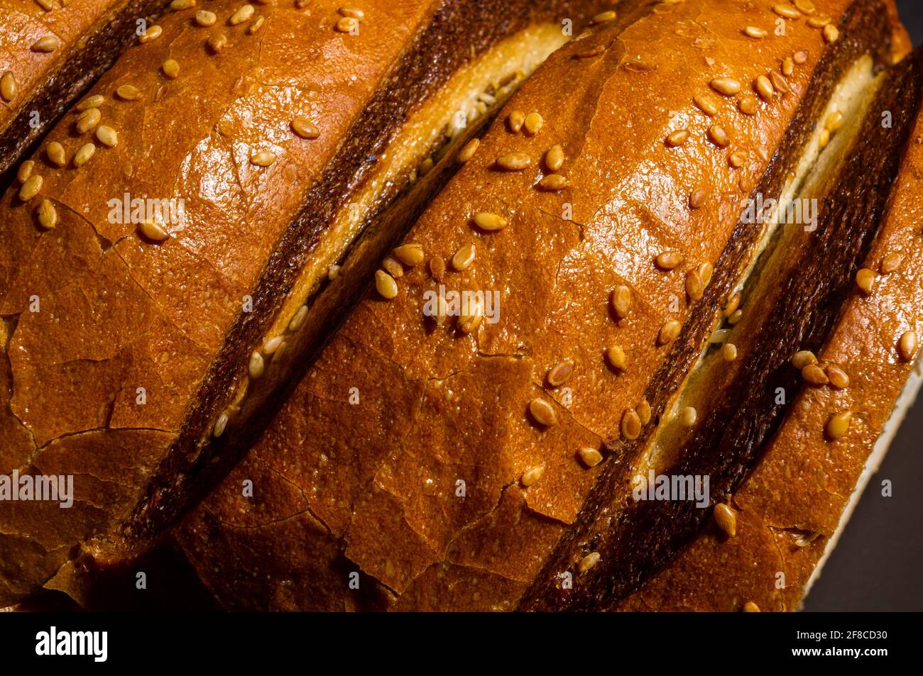 Unusual two-color fresh loaf of bread on a black background, photo in a ...