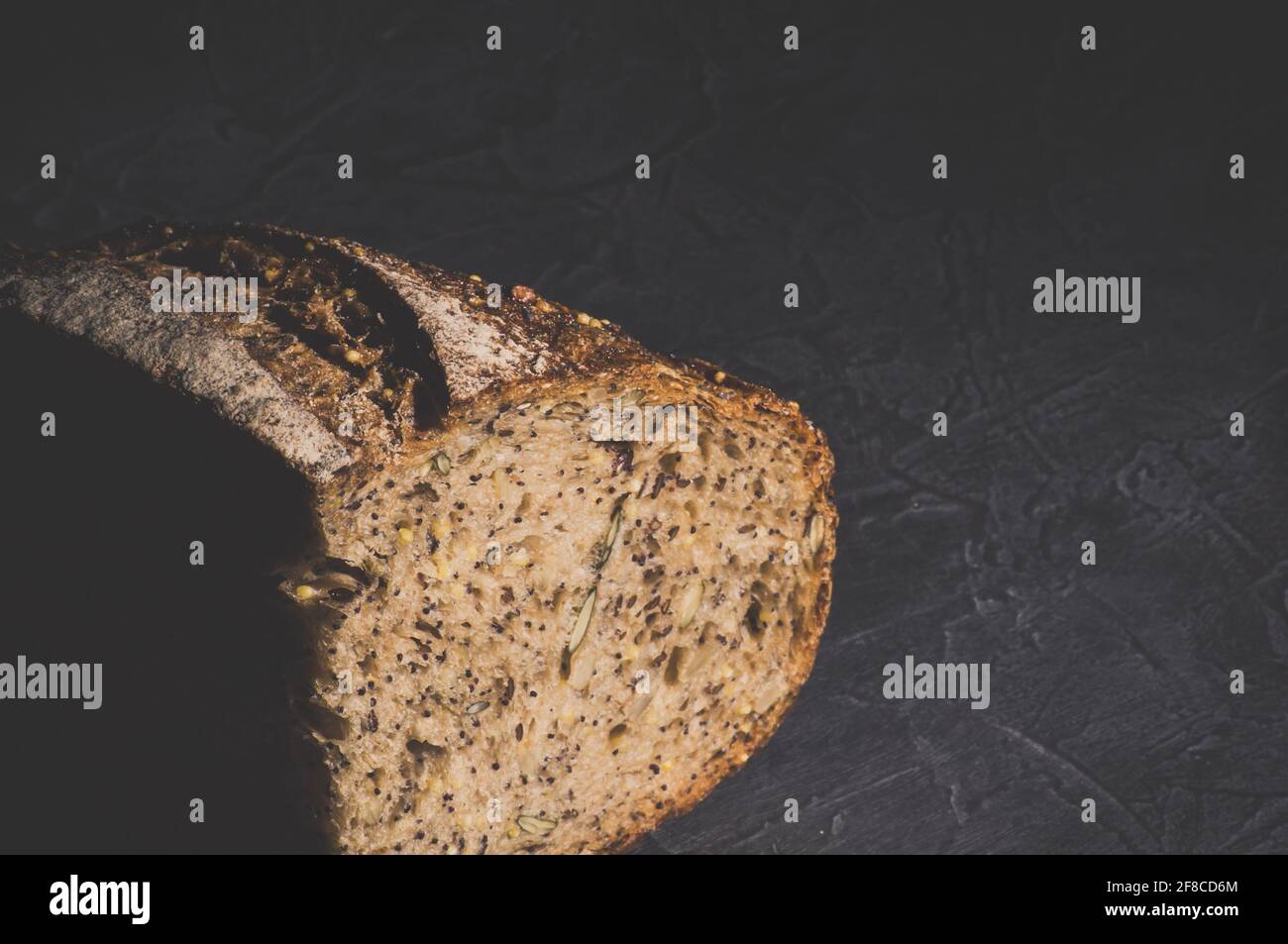 Slice of rustic natural yeast-free bread with flax, poppy seeds, sesame ...