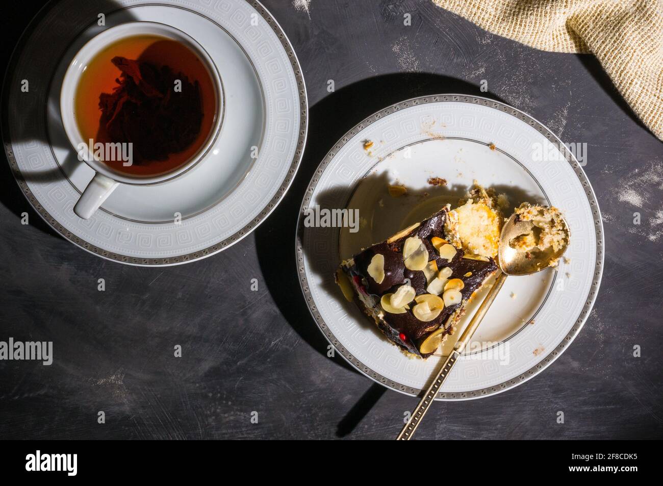 Still life - layered homemade sponge cake and a cup of black tea in a ...