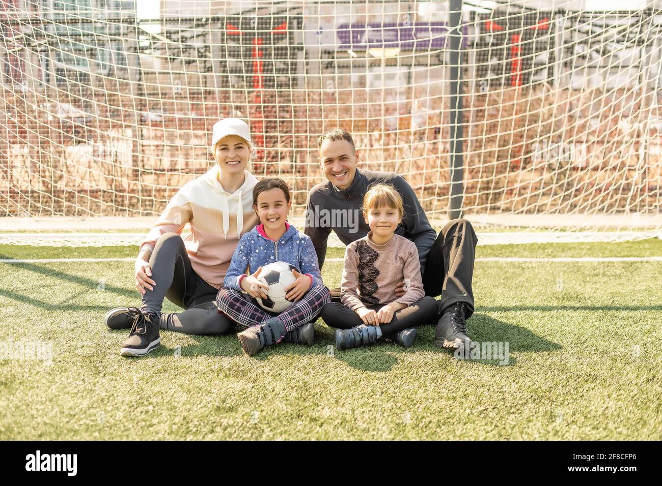 family and ball on the grass in the stadium Stock Photo - Alamy