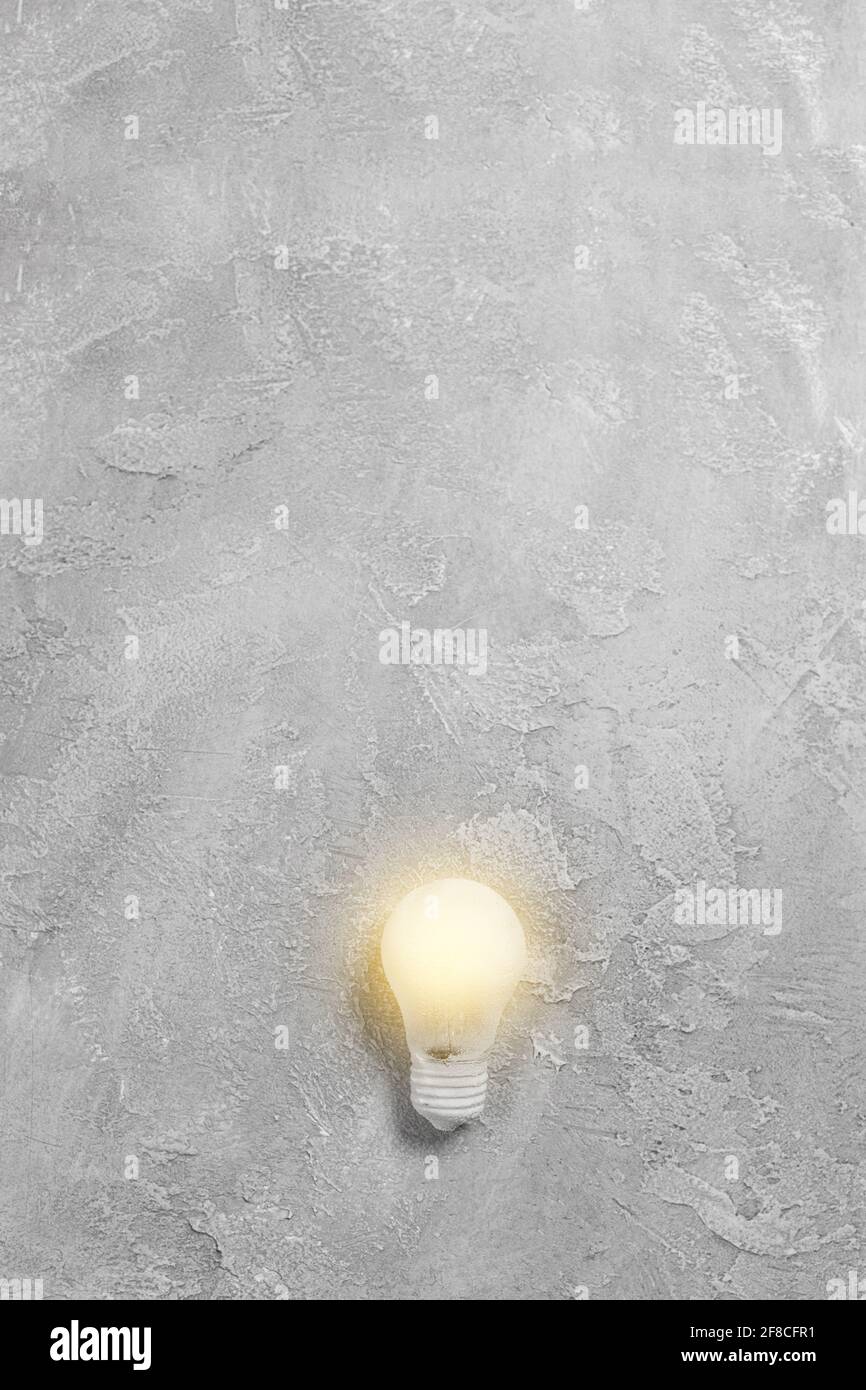 Bright idea illuminated light bulb on grey background. Creative ...
