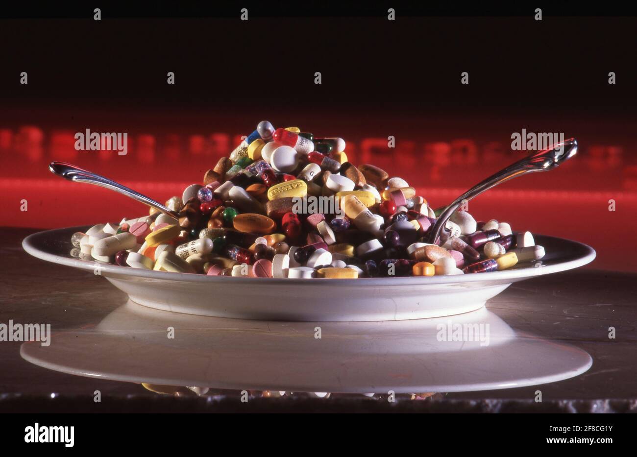 Illustration on abuse of prescription drugs. Dinnertime -- pills and ...