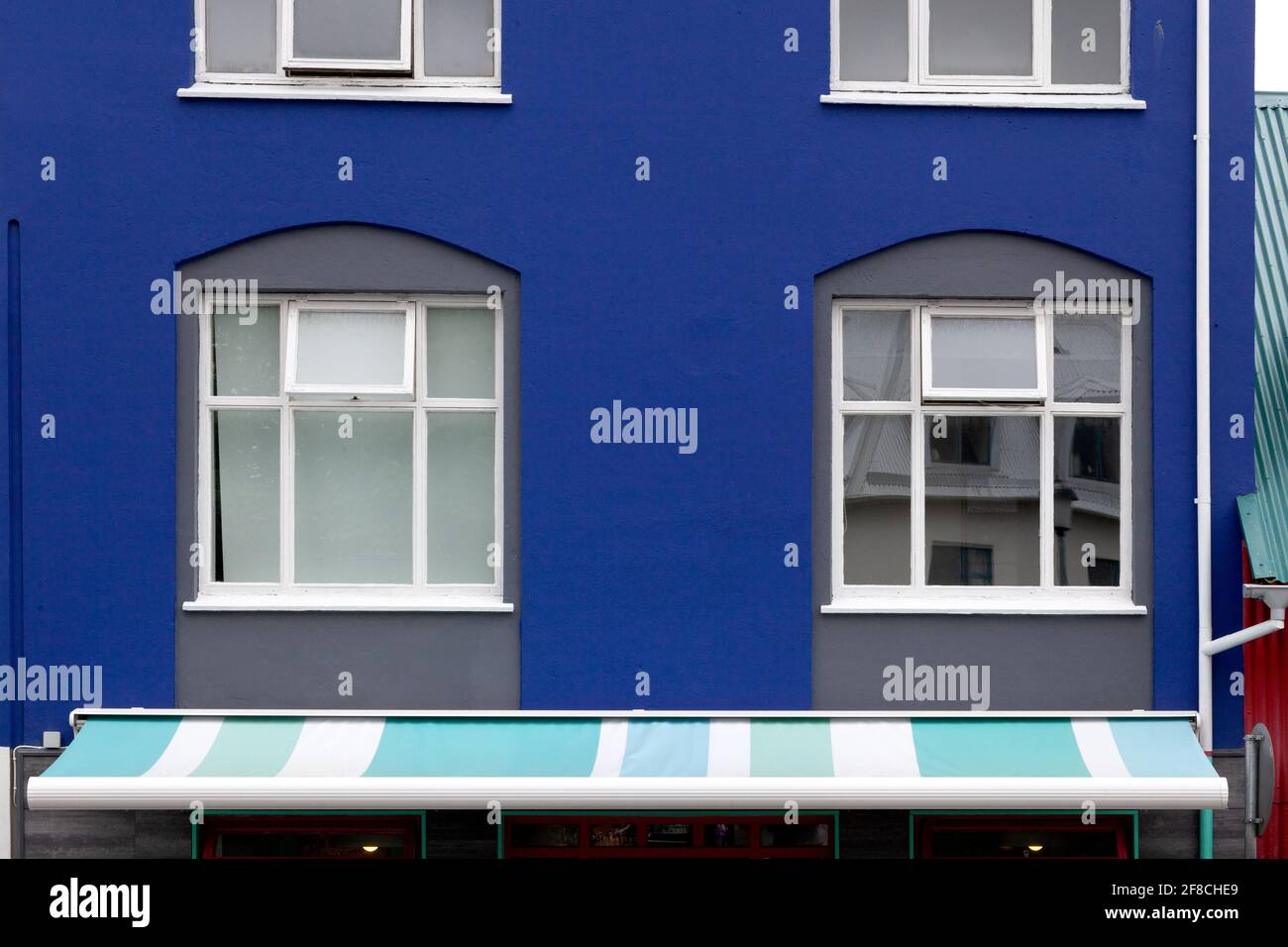 Reykjavik, Iceland - 17 June 2014: Windows on the bright blue wall ...