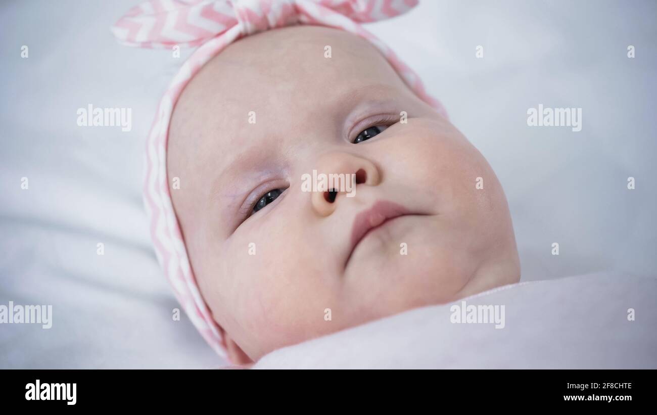 Serious baby girl sitting hi-res stock photography and images - Alamy