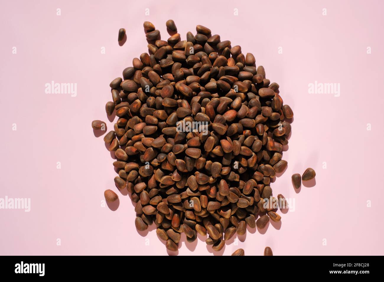 Pine nuts heap on a pink background. Nuts and seeds. cedar nuts ...