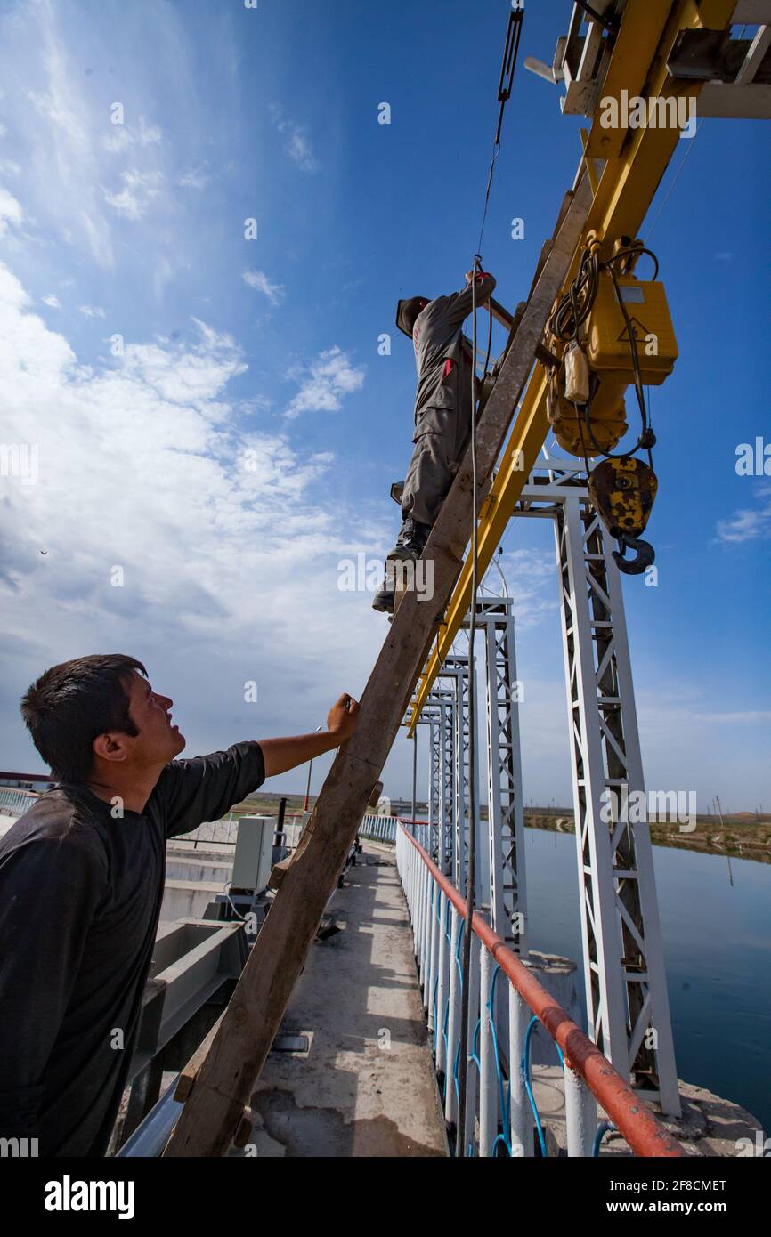 Kazakhstan, Shardara water storage dam. Asian (Uzbek) electrician ...