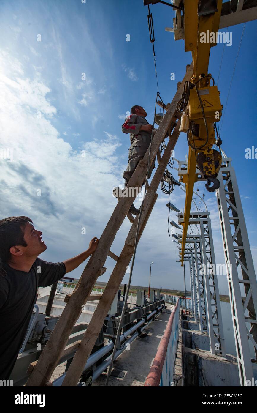 Kazakhstan, Shardara water storage dam. Asian (Uzbek) electrician ...