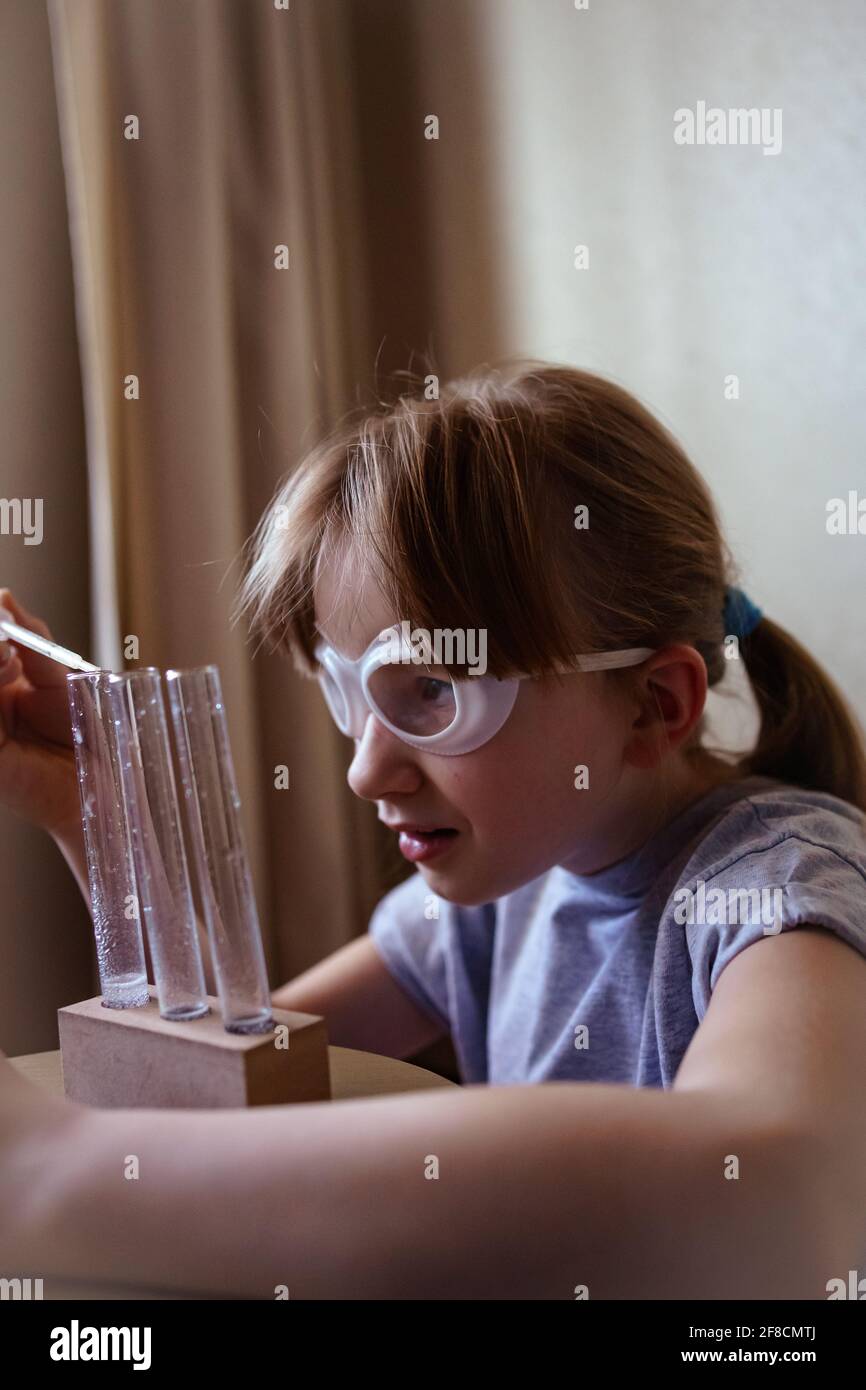 a girl in goggles conducts chemical experiments at home Stock Photo - Alamy
