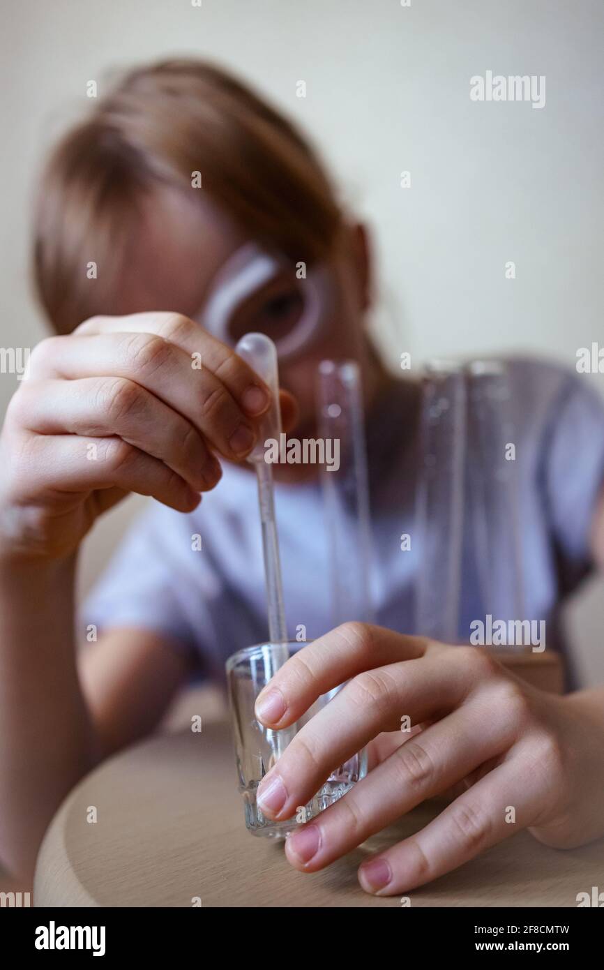 a girl in goggles conducts chemical experiments at home Stock Photo - Alamy