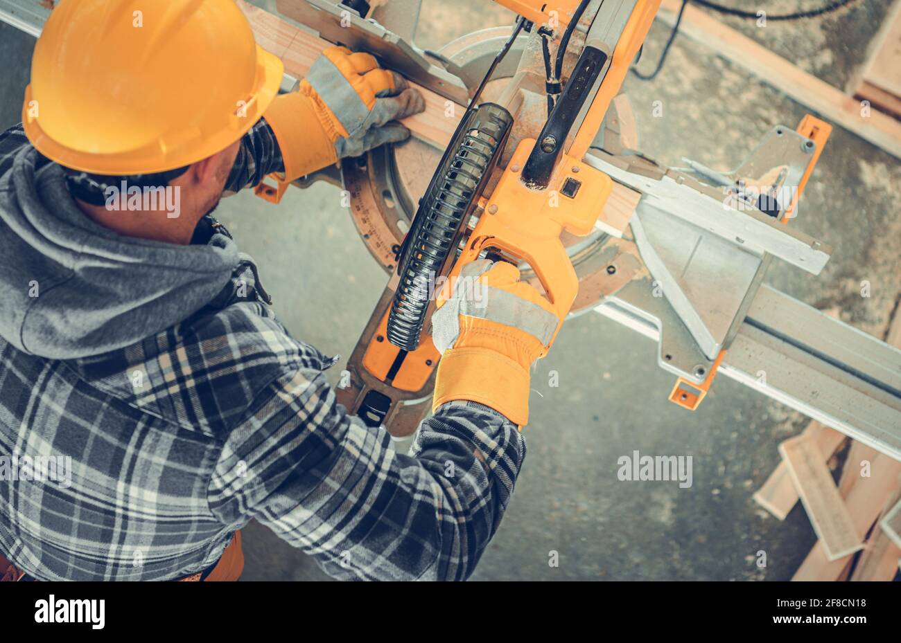 Construction Site Worker Using Powerful Circular Saw to Cut Piece of ...
