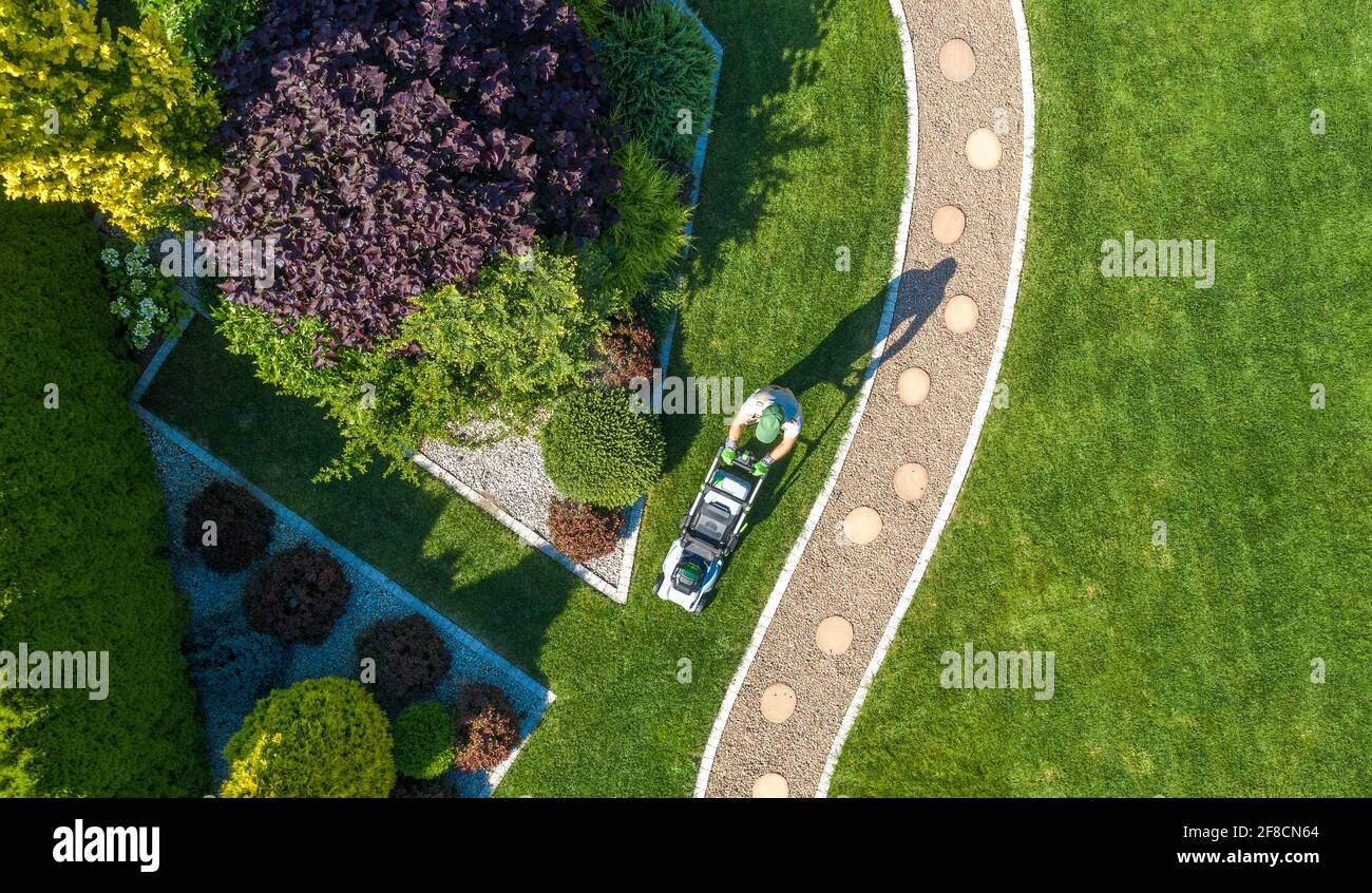 Landscaping Job Grass Mowing Aerial View. Caucasian Gardener with Grass ...