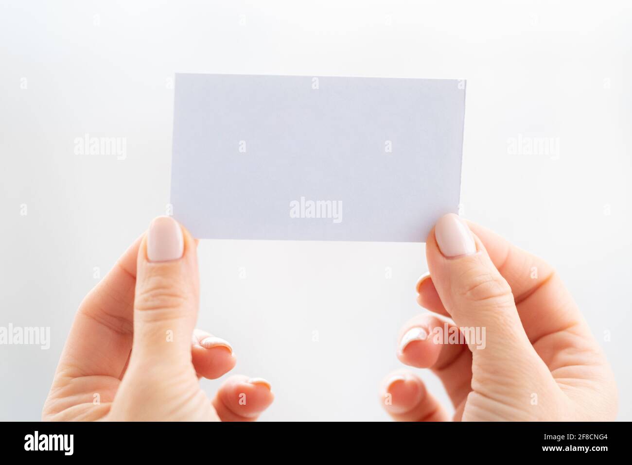 Hand holding empty white business card Stock Photo - Alamy