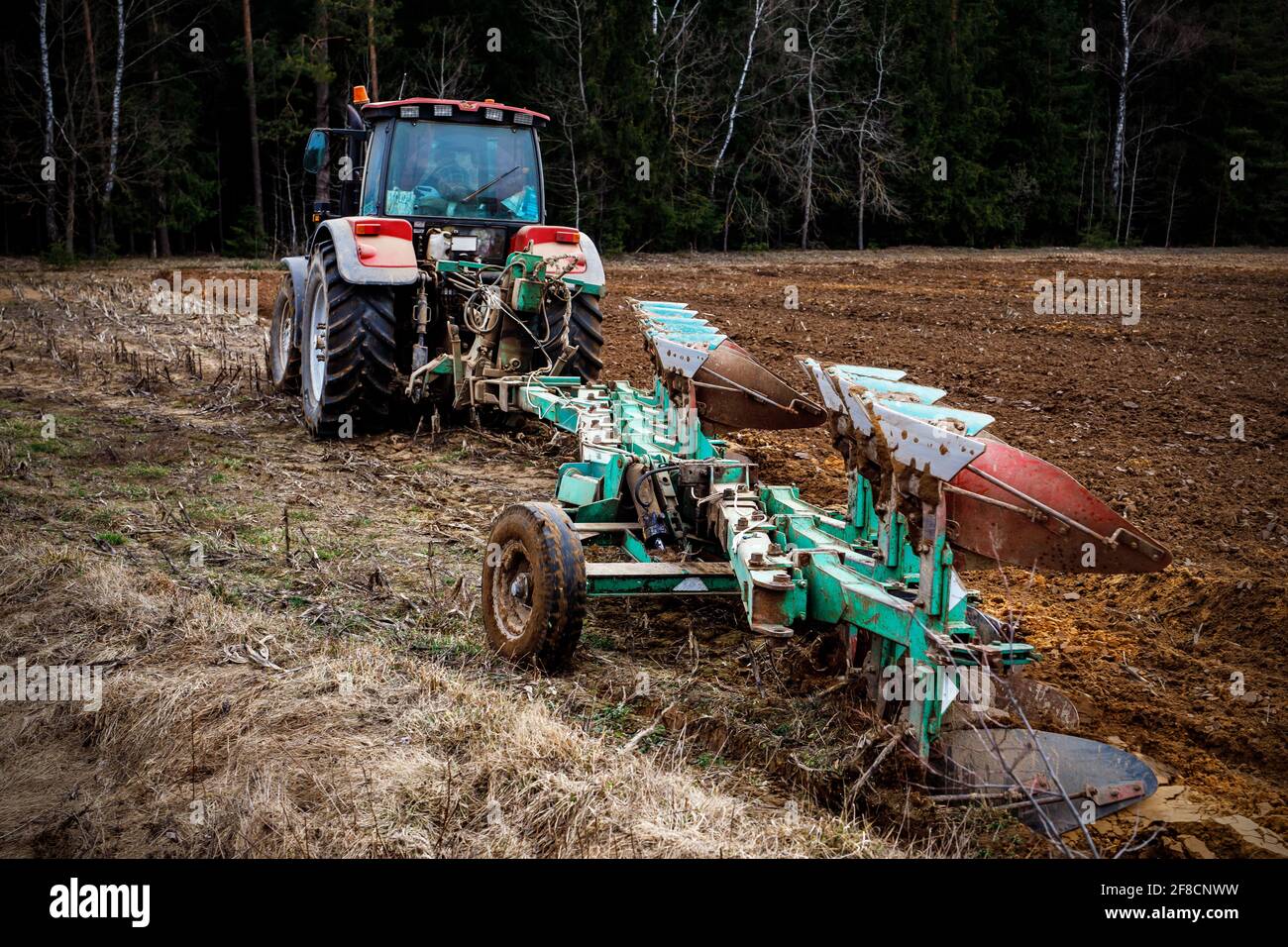 Tractor plowing fields - preparing land for sowing Stock Photo - Alamy