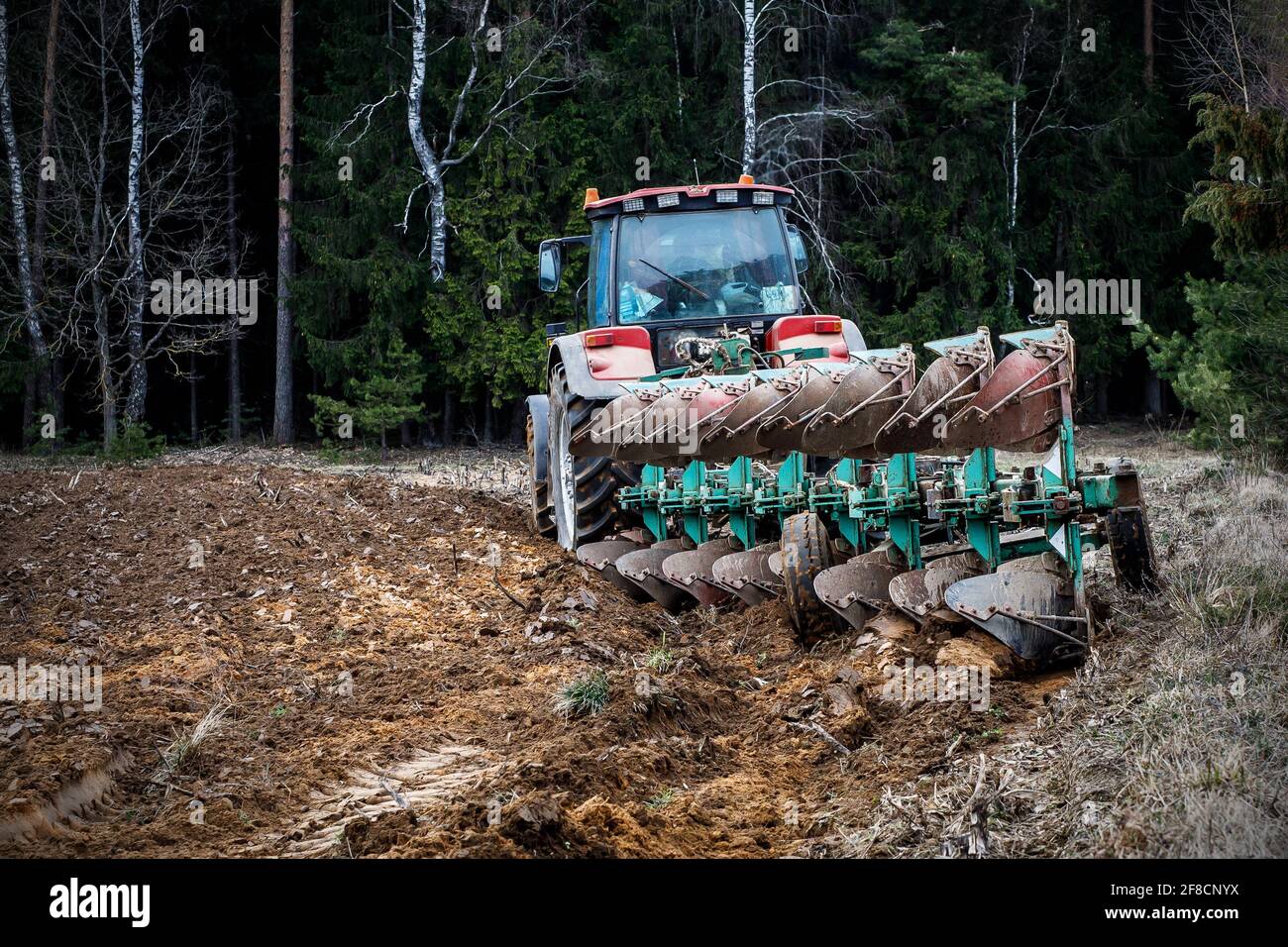 Tractor plowing fields - preparing land for sowing Stock Photo - Alamy