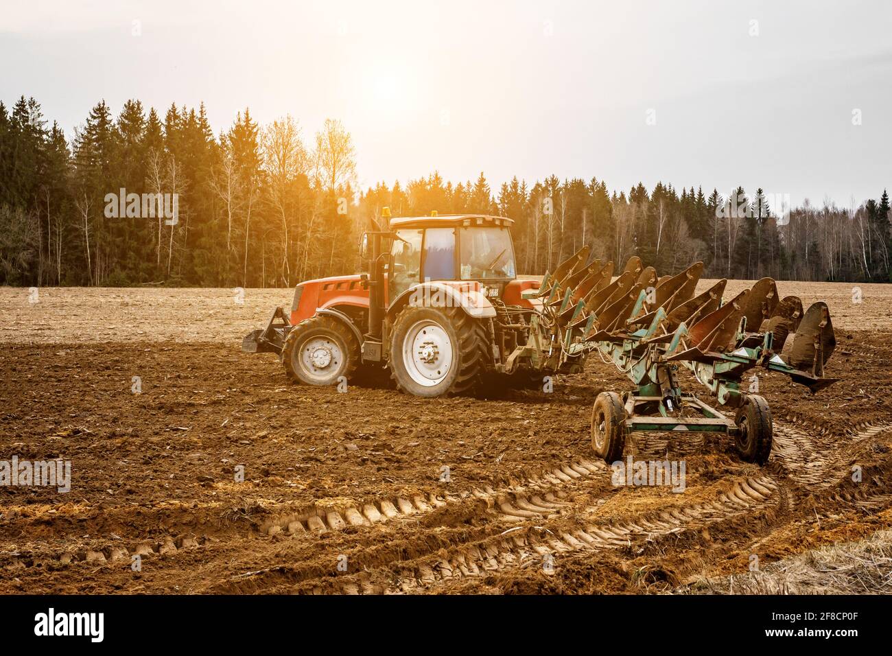 Tractor plowing fields - preparing land for sowing Stock Photo - Alamy