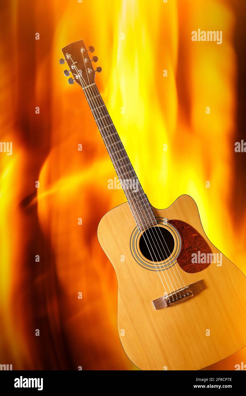 Acoustic guitar on a fire background Stock Photo - Alamy
