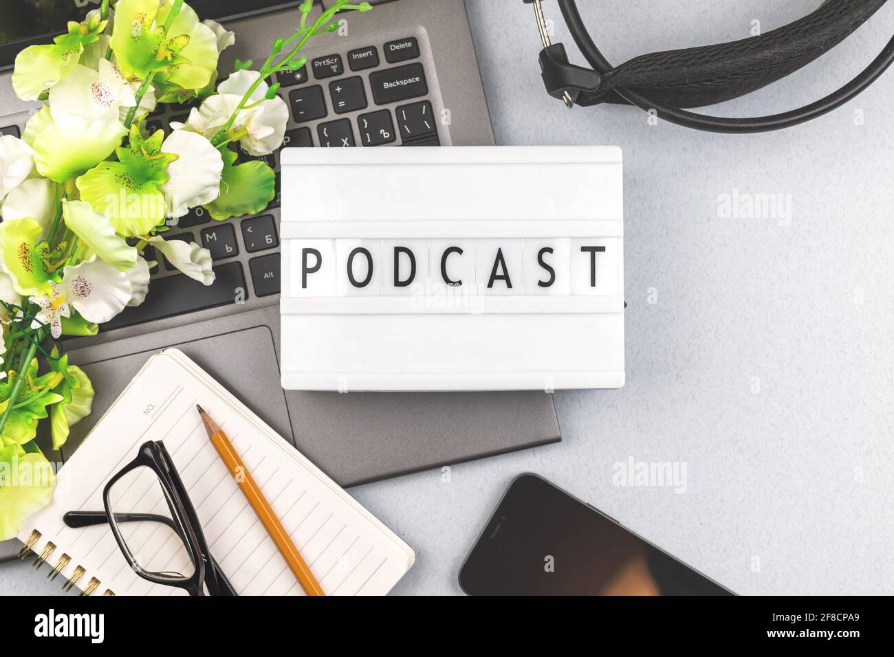 Podcast word on lightbox creative broadcast flat lay background, office ...