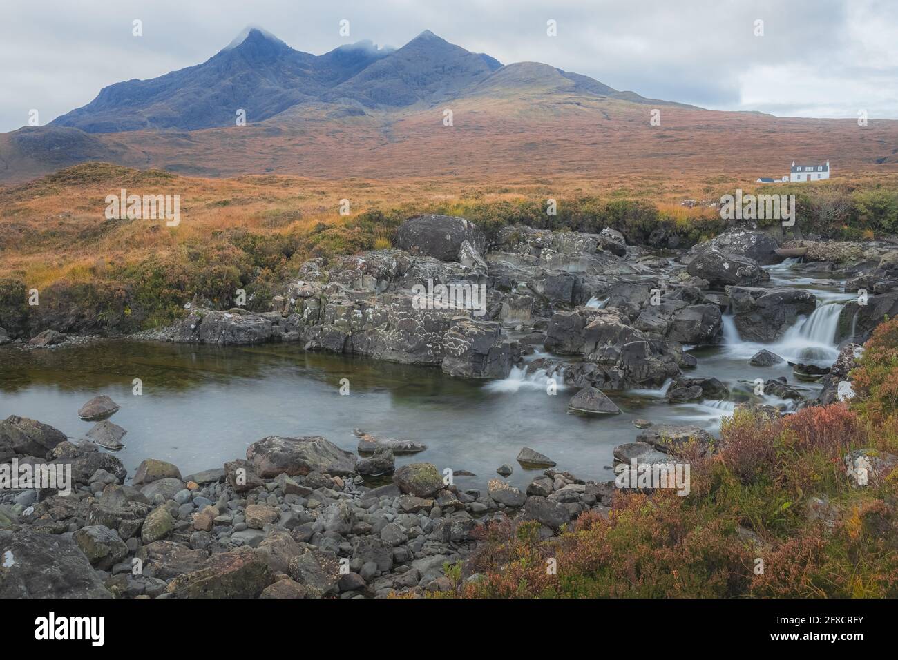 Scenic landscape view of the Black Cuillin mountains and a lone white ...