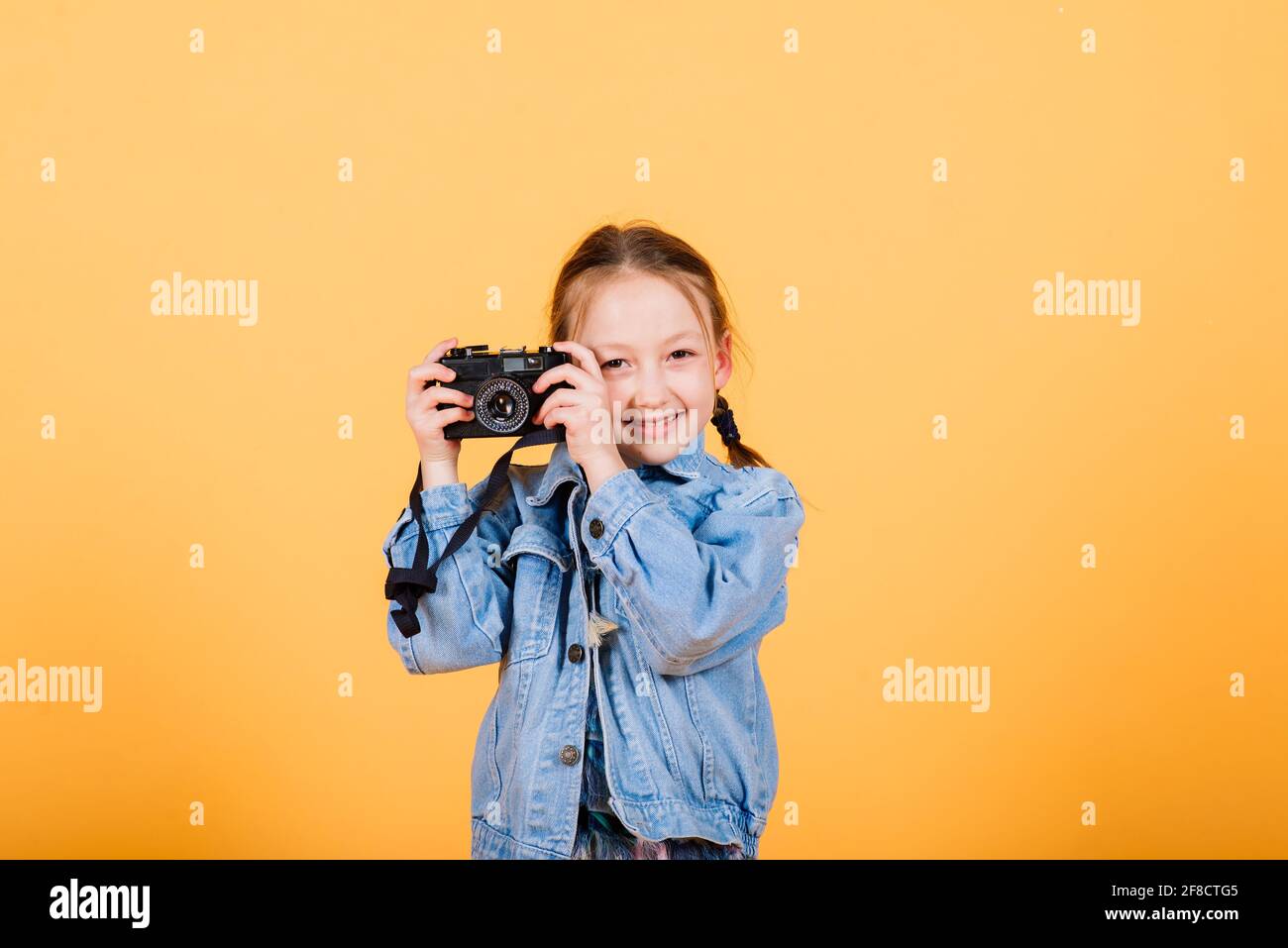Child with camera. Little girl photographing in studio Stock Photo - Alamy
