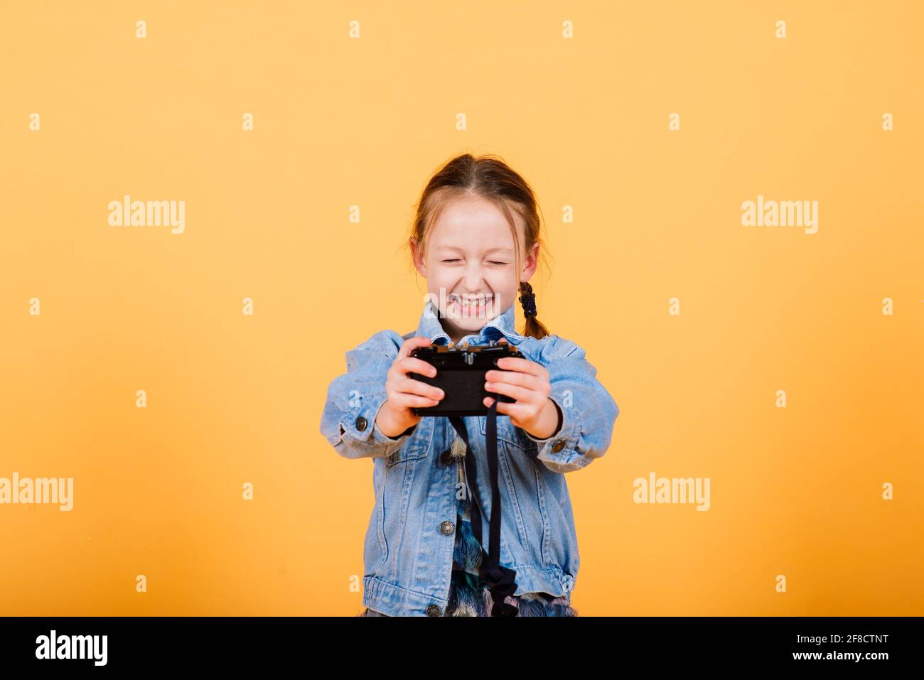 Child with camera. Little girl photographing in studio Stock Photo - Alamy