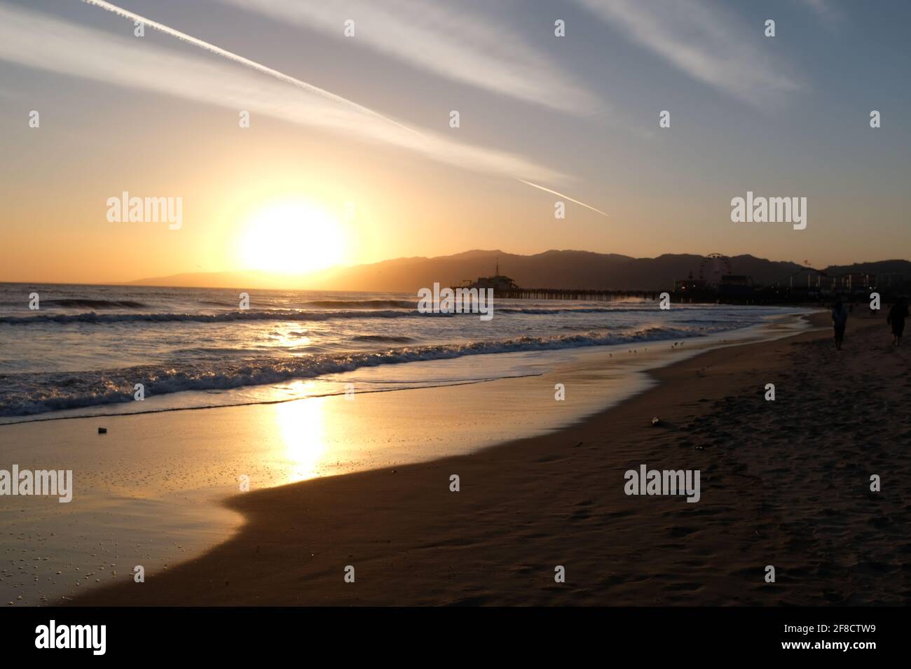 Sunset at Santa Monica Beach, California. The golden color of the sand ...