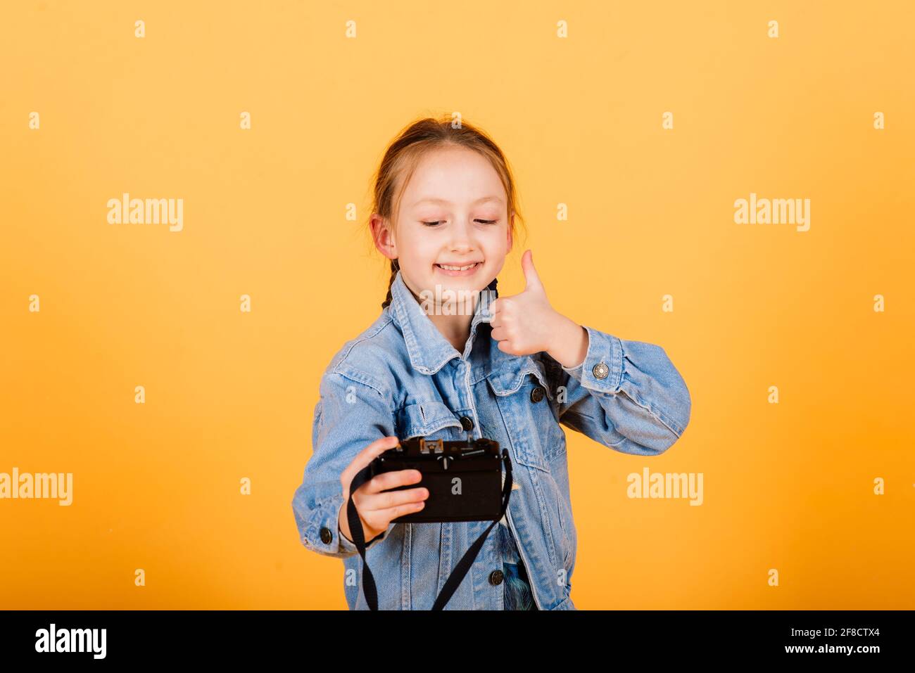 Child with camera. Little girl photographing in studio Stock Photo - Alamy