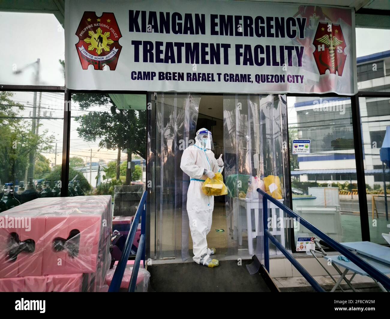 Healthcare worker wearing personal protective equipment prepares ...