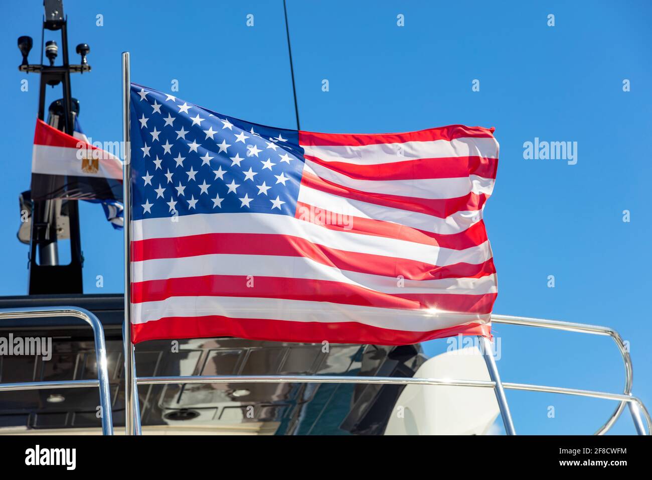United states of America flag waving on yacht stern. Luxury boat moored ...